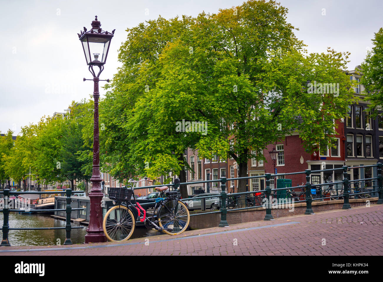 Traditional dutch bicycle parked on canal in Amsterdam Stock Photo - Alamy