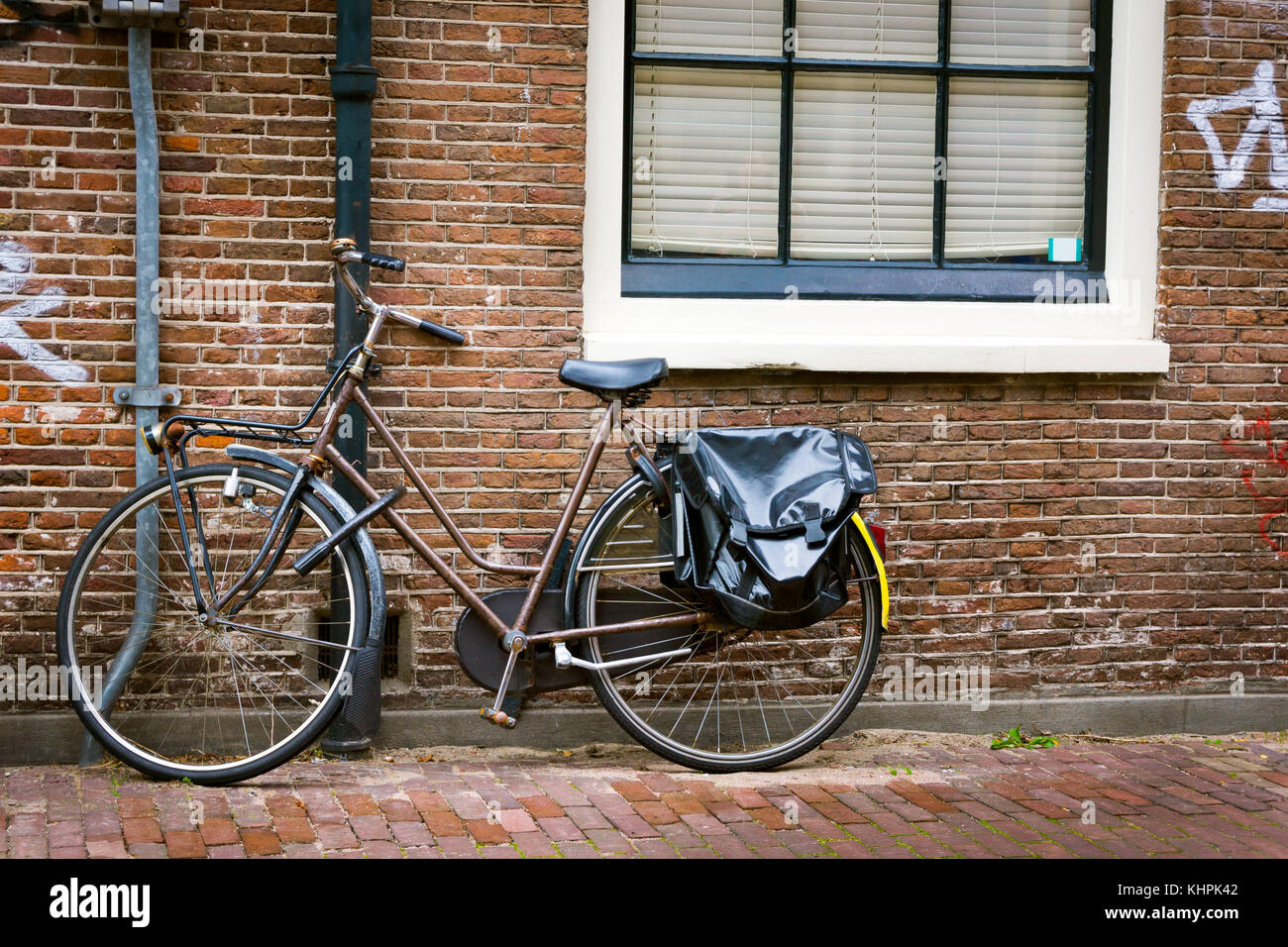 Traditional dutch bicycle parked on near brick wall in Amsterdam Stock ...