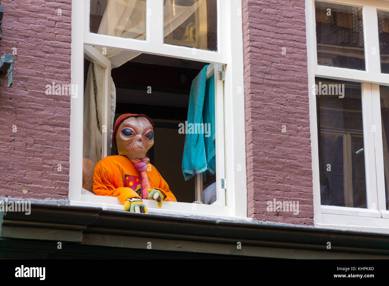 Alien in the window in the city Stock Photo - Alamy