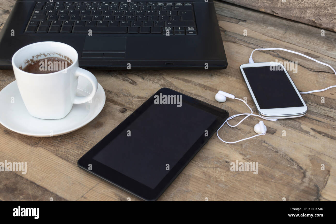 Office desktop with laptop, tablet, coffee cup and smartphone Stock ...
