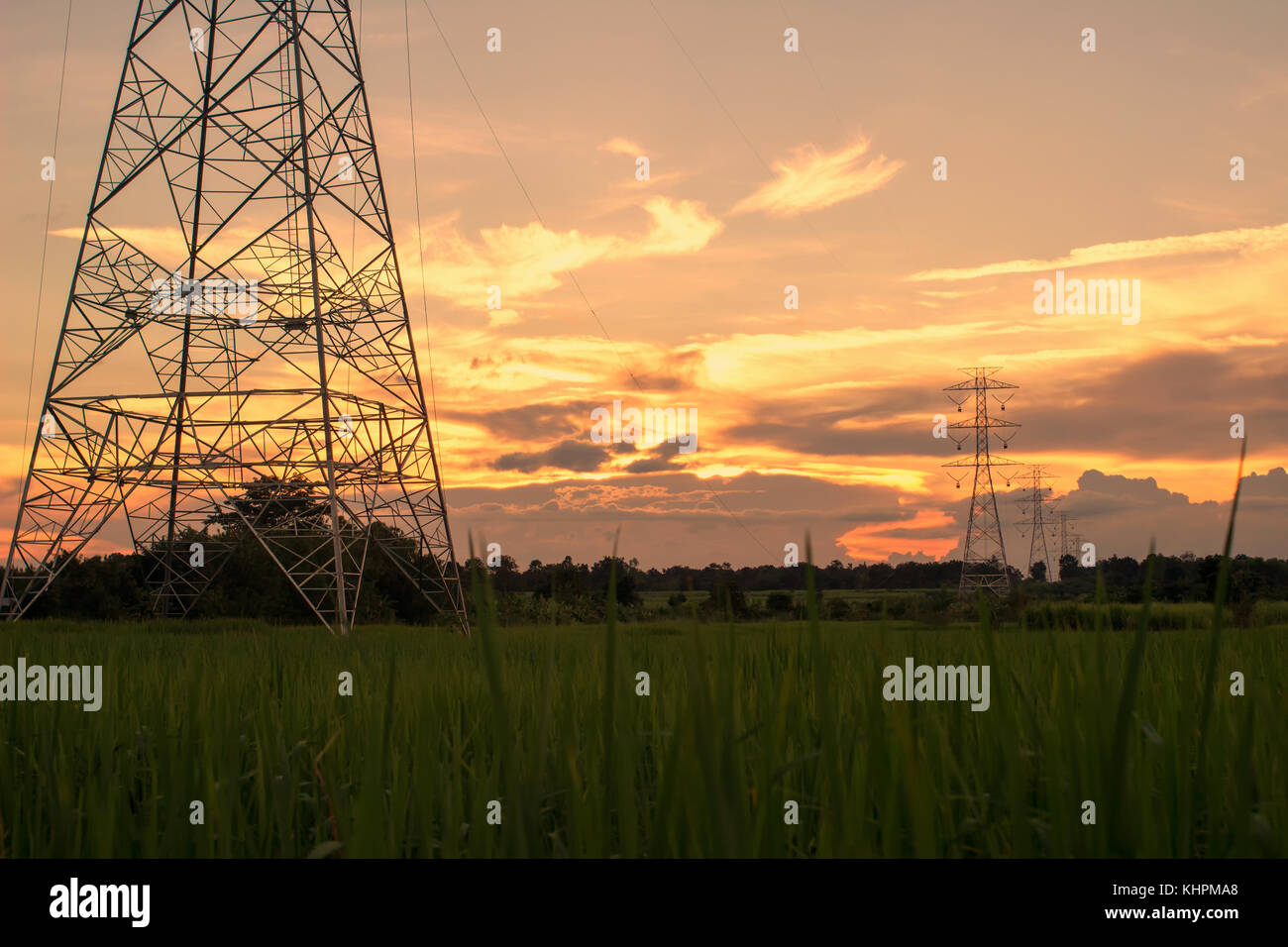 High-power pylon with sunset Stock Photo - Alamy
