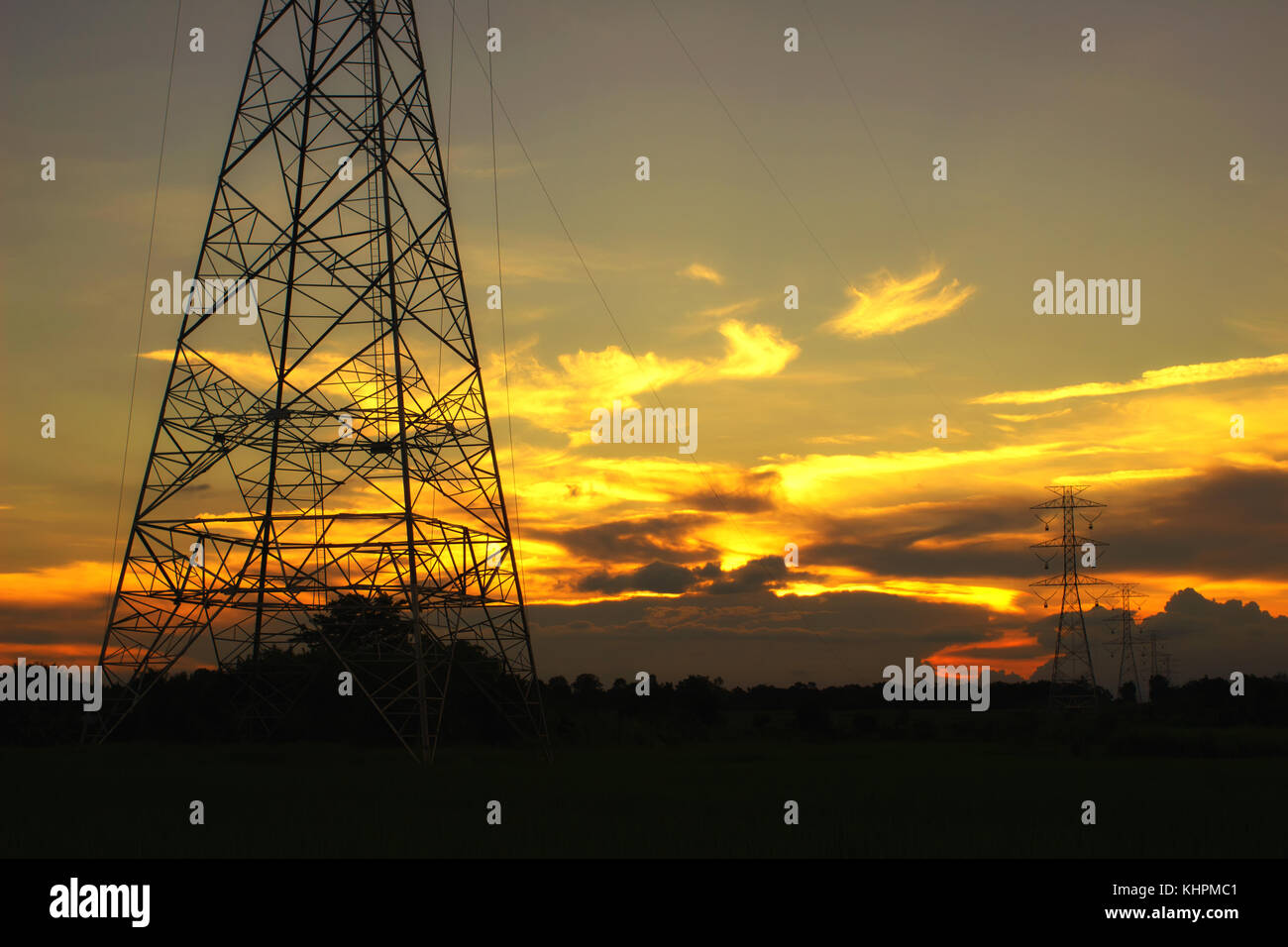 High-power pylon with sunset Stock Photo - Alamy