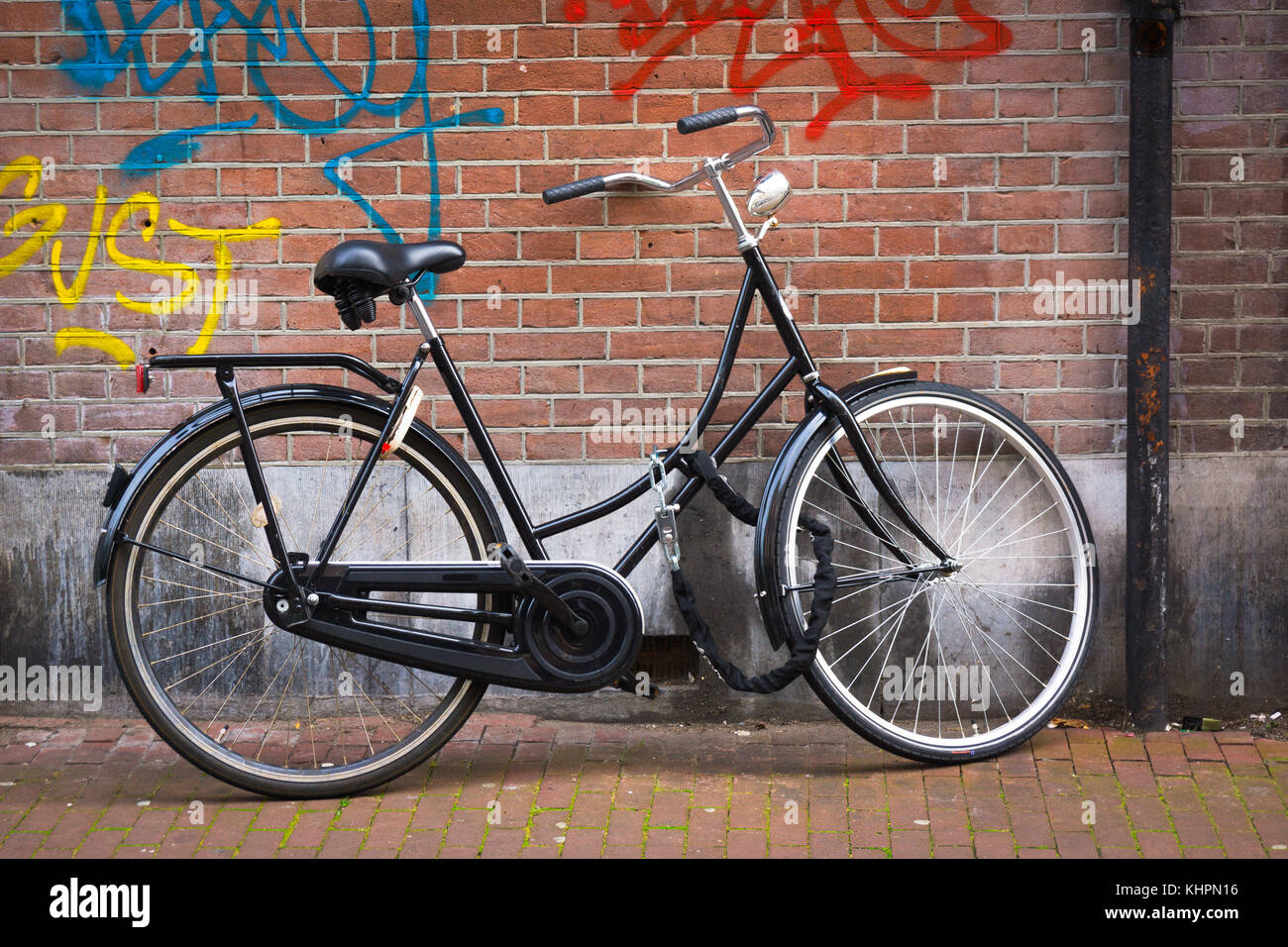 Traditional dutch bicycle parked on near brick wall in Amsterdam Stock ...