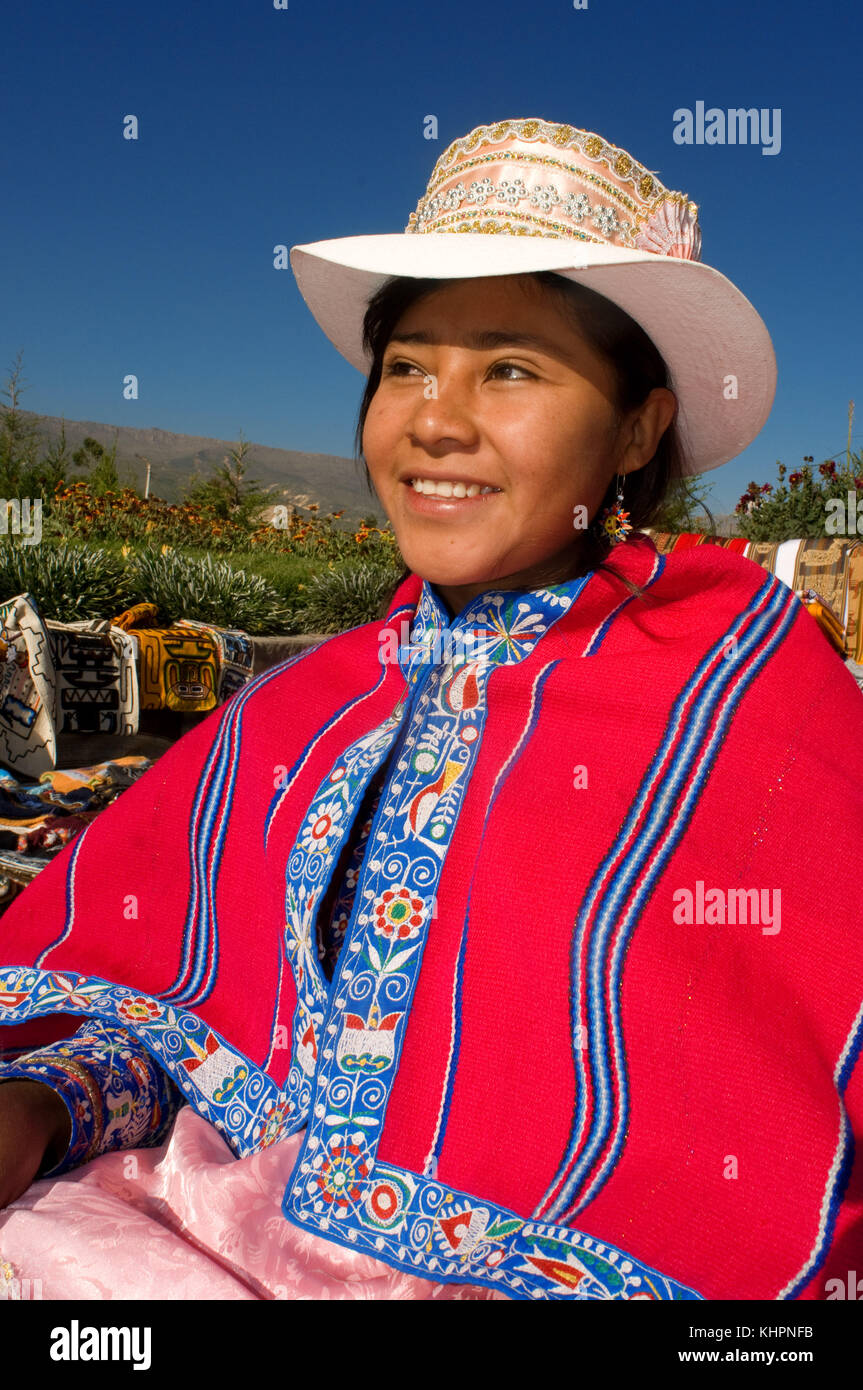 A saleswoman dressed in her typical regional costume in Yanke, one of ...