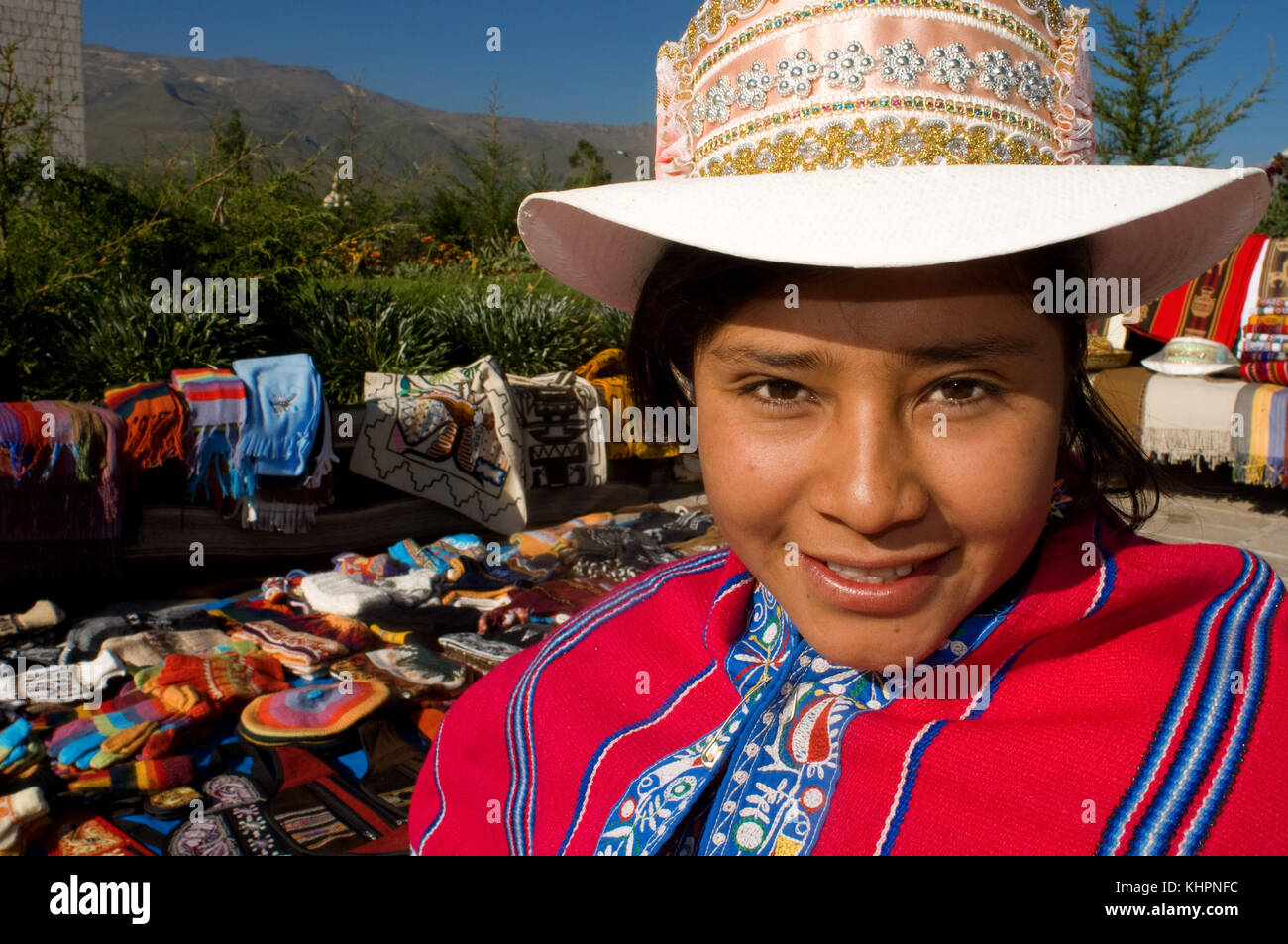A saleswoman dressed in her typical regional costume in Yanke, one of ...