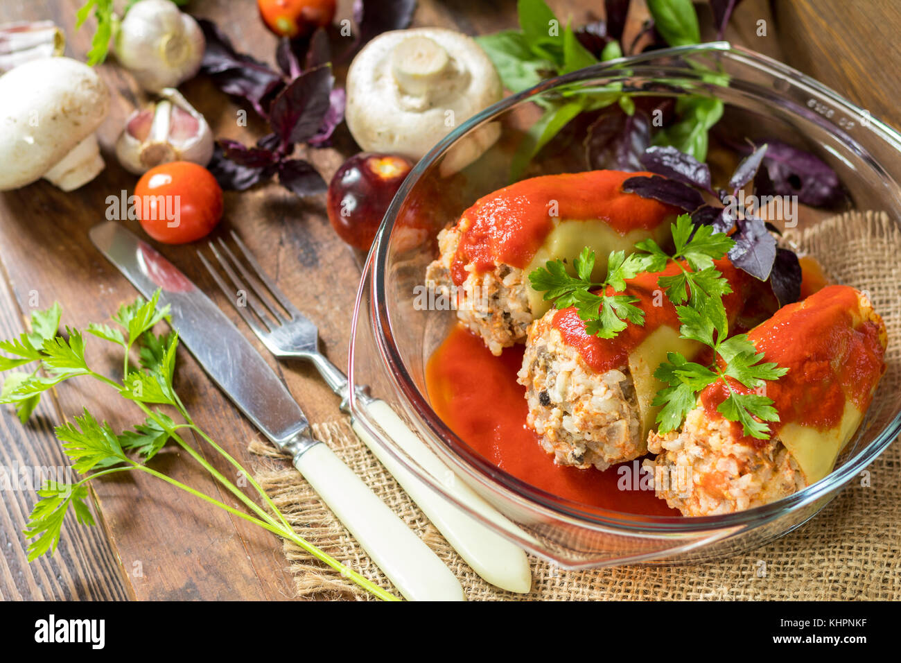Yummy looking cooked stuffed pepper served in a transparent glass pot ...