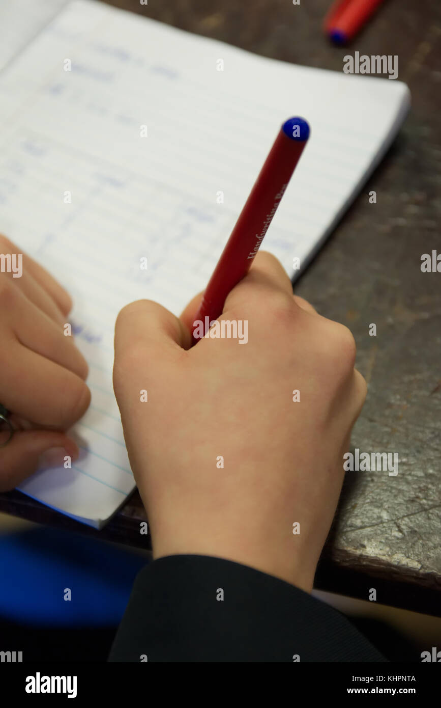 School pupil writing notes in exercise book, student, hands notebook ...