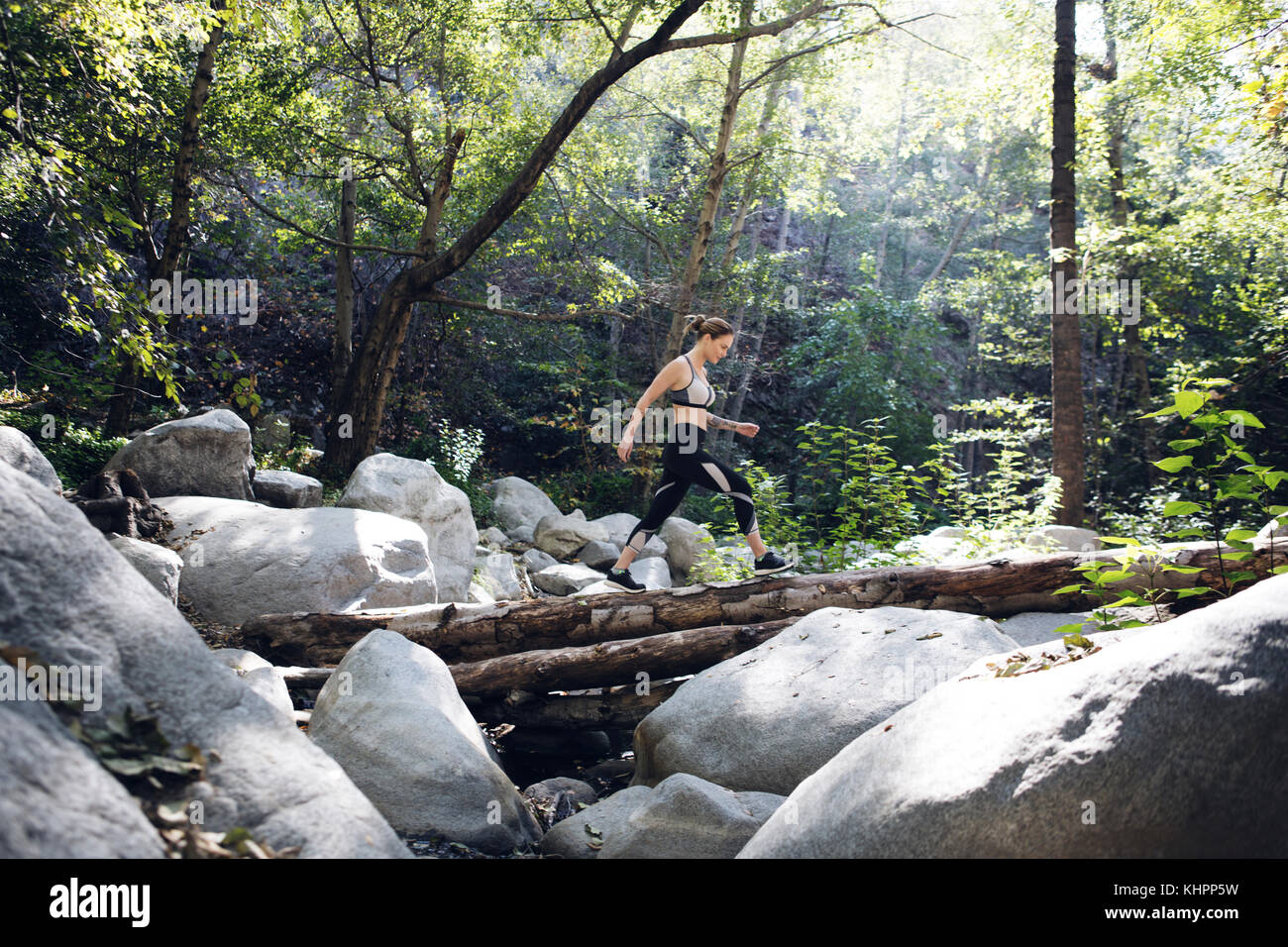 Female Athlete Running and Doing Yoga in Forest Stock Photo - Alamy