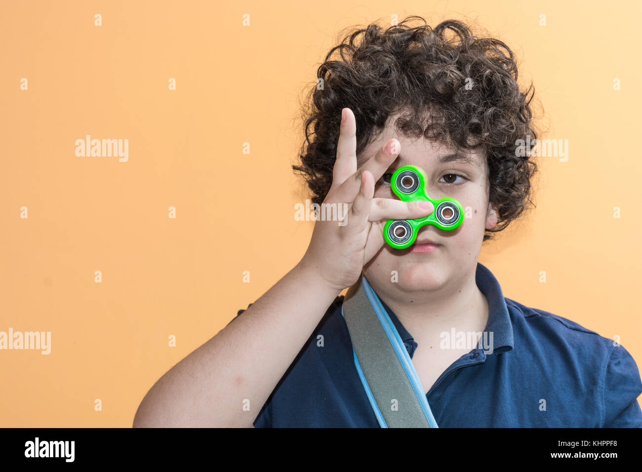 Boy playing with fidget spinner gadget. The fidget spinner is a toy, a ...