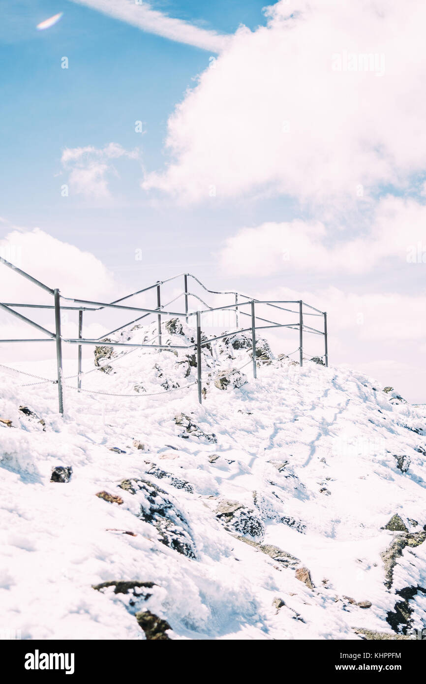 Steel railing balustrade on a mountain peak covered in snow Stock Photo ...