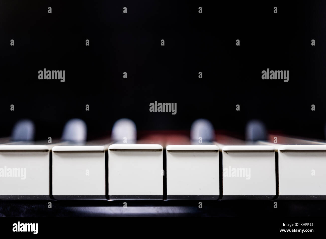 Artistic flat front view of clean piano keys with blank black space ...