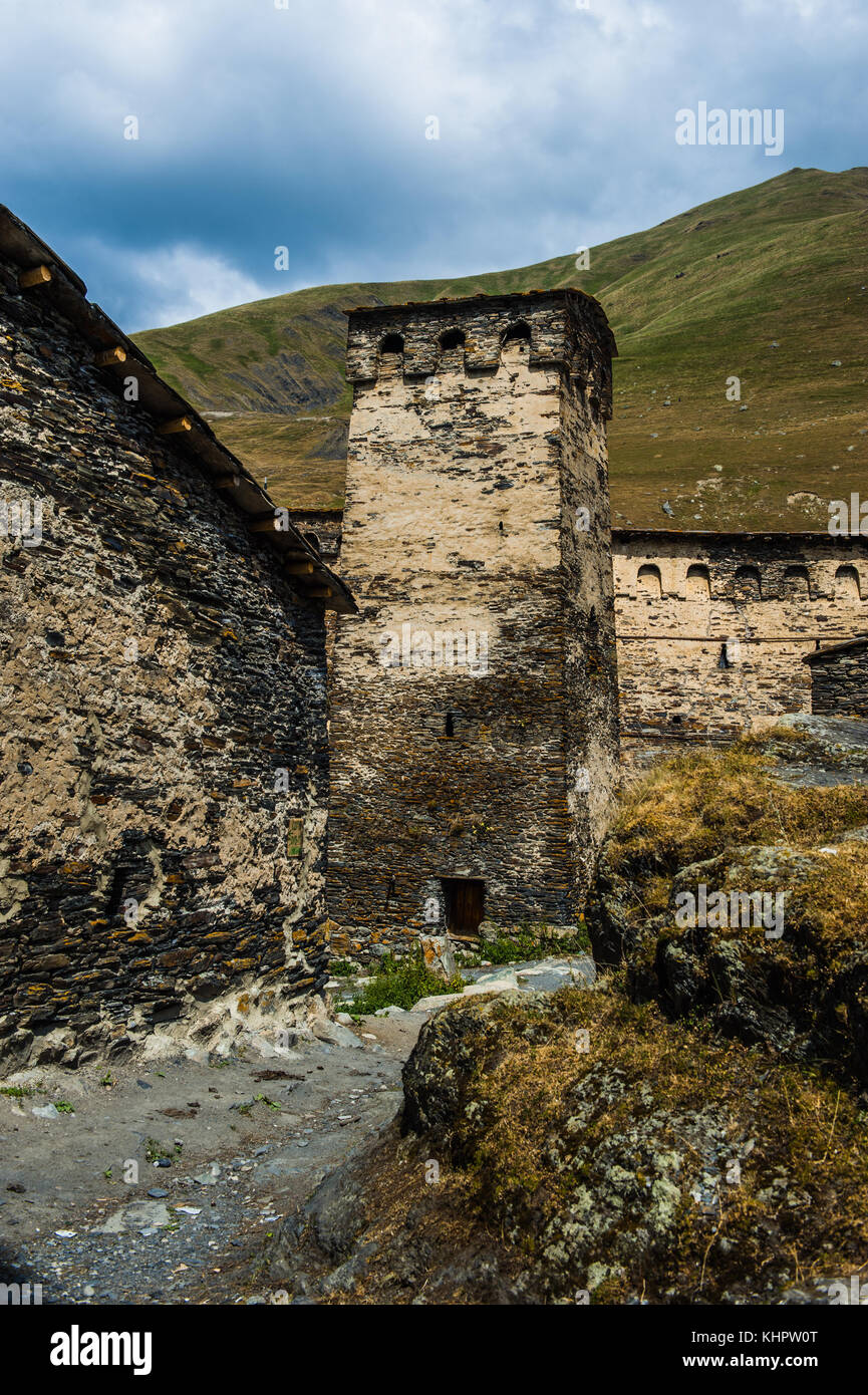 Village Ushguli landscape with massive rocky mountains Bezengi wall ...