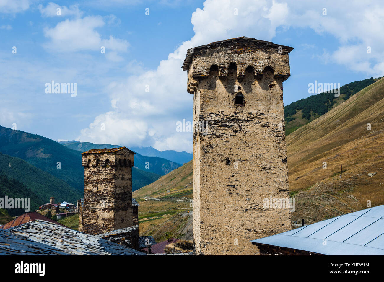 Village Ushguli landscape with massive rocky mountains Bezengi wall ...