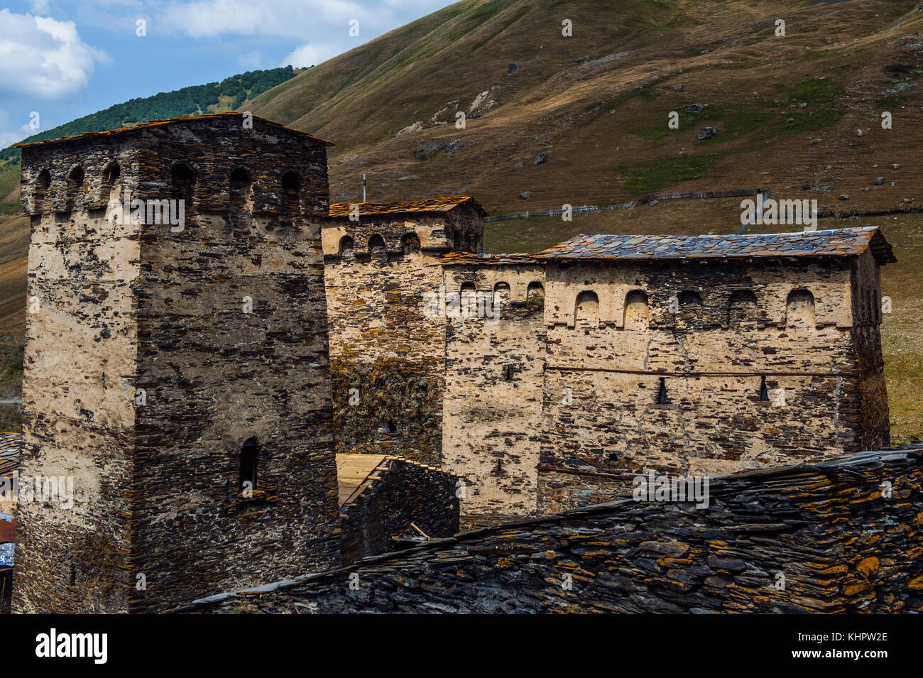 Village Ushguli landscape with massive rocky mountains Bezengi wall ...