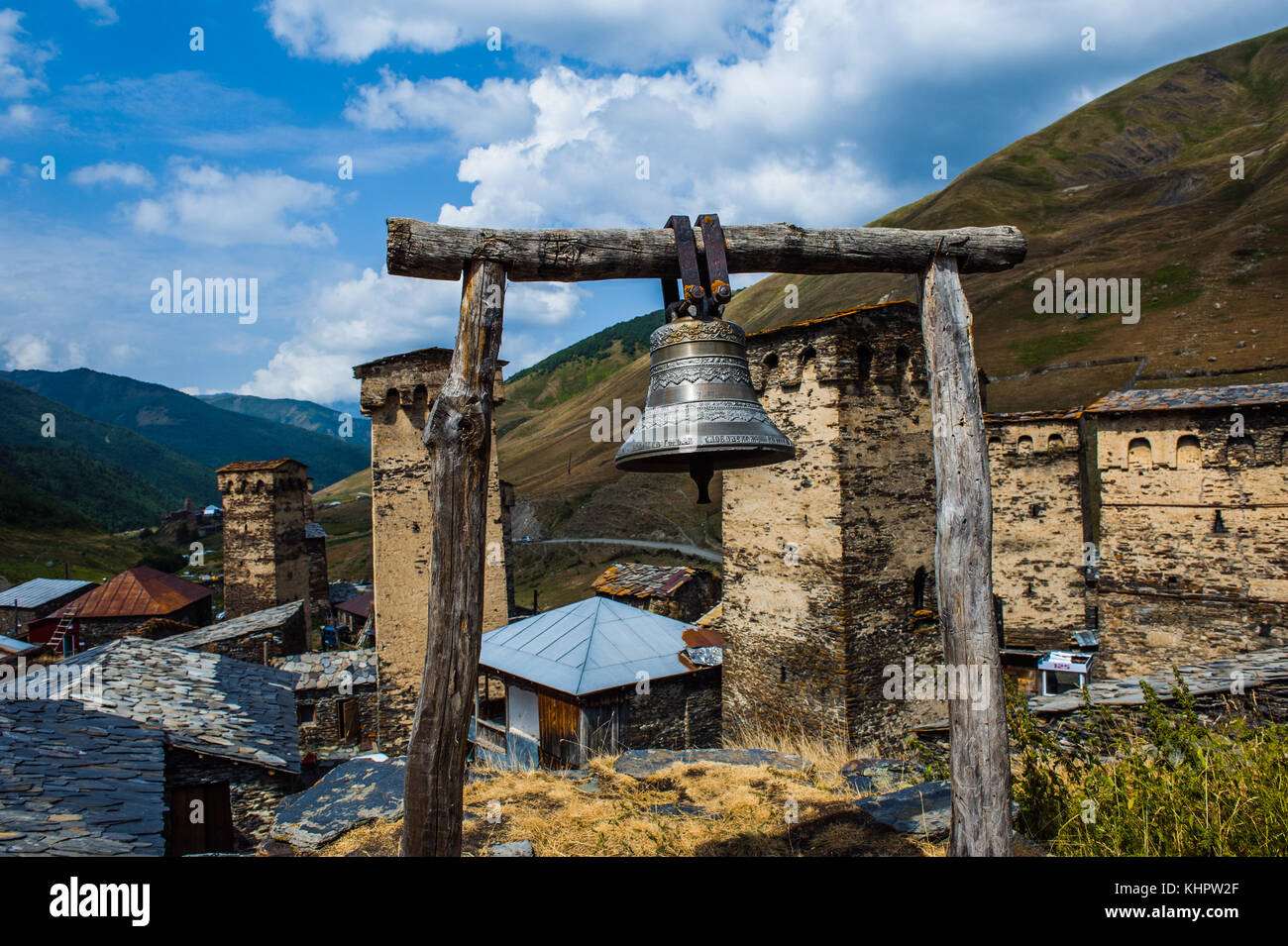 Village Ushguli landscape with massive rocky mountains Bezengi wall ...