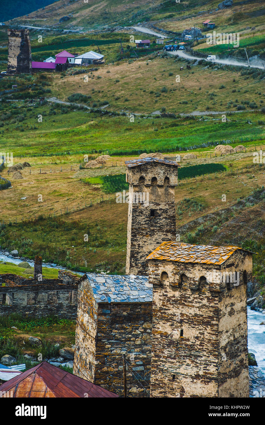 Village Ushguli landscape with massive rocky mountains Bezengi wall ...
