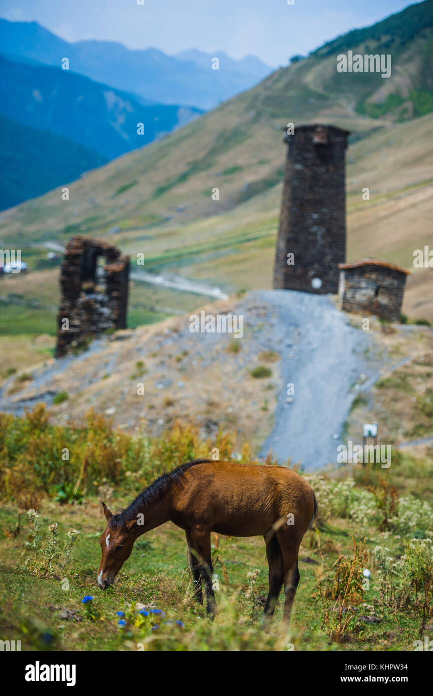 Village Ushguli landscape with massive rocky mountains Bezengi wall ...