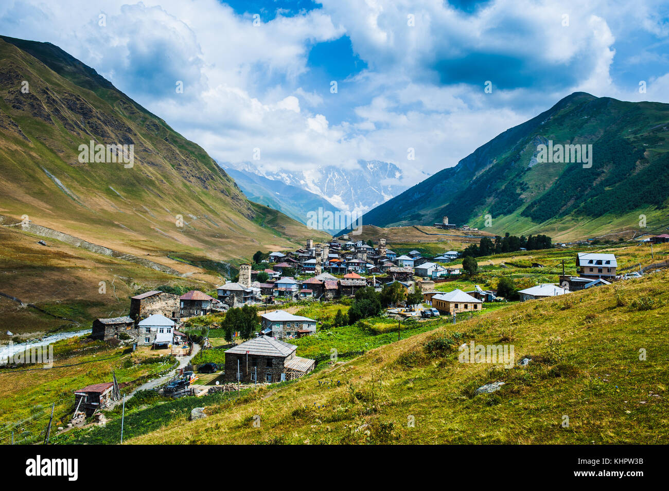 Village Ushguli landscape with massive rocky mountains Bezengi wall ...