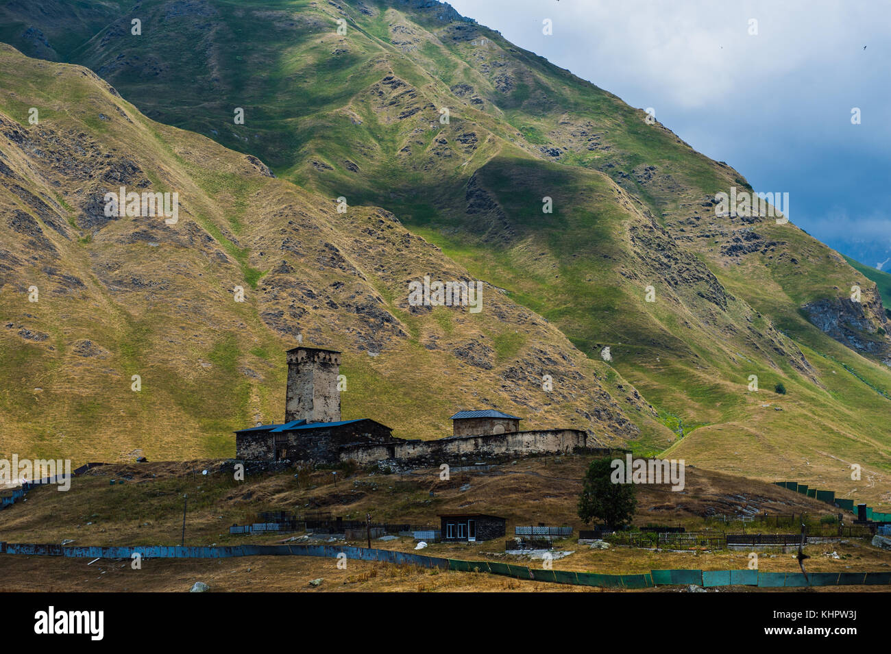 Village Ushguli landscape with massive rocky mountains Bezengi wall ...