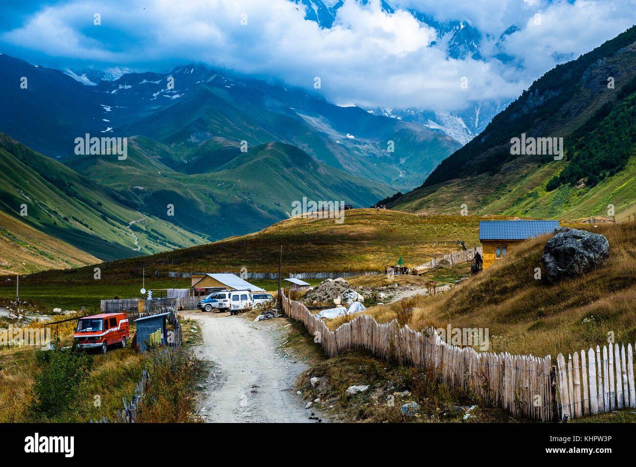 Village Ushguli landscape with massive rocky mountains Bezengi wall ...