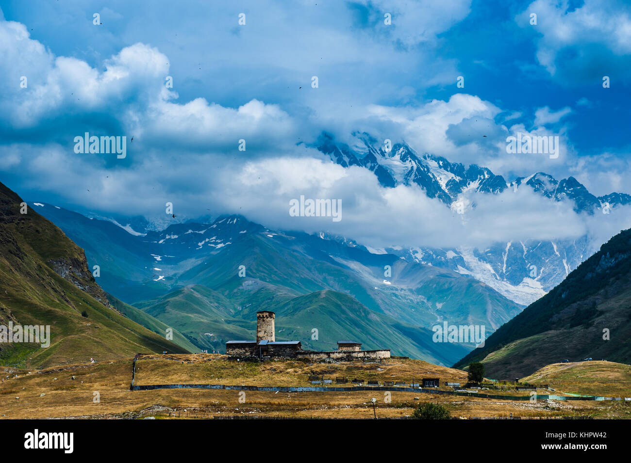 Village Ushguli landscape with massive rocky mountains Bezengi wall ...