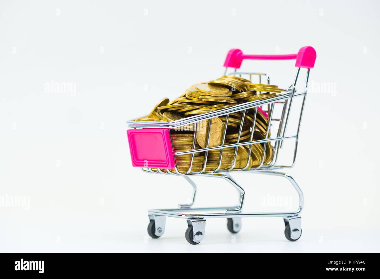 Stack of coins in shopping cart or supermarket trolley on white ...
