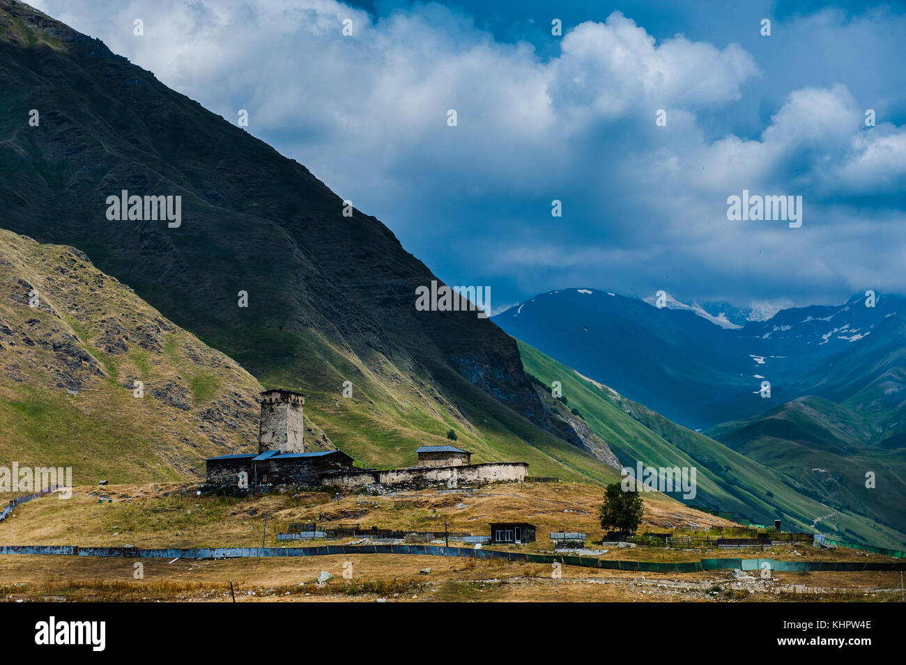 Village Ushguli landscape with massive rocky mountains Bezengi wall ...