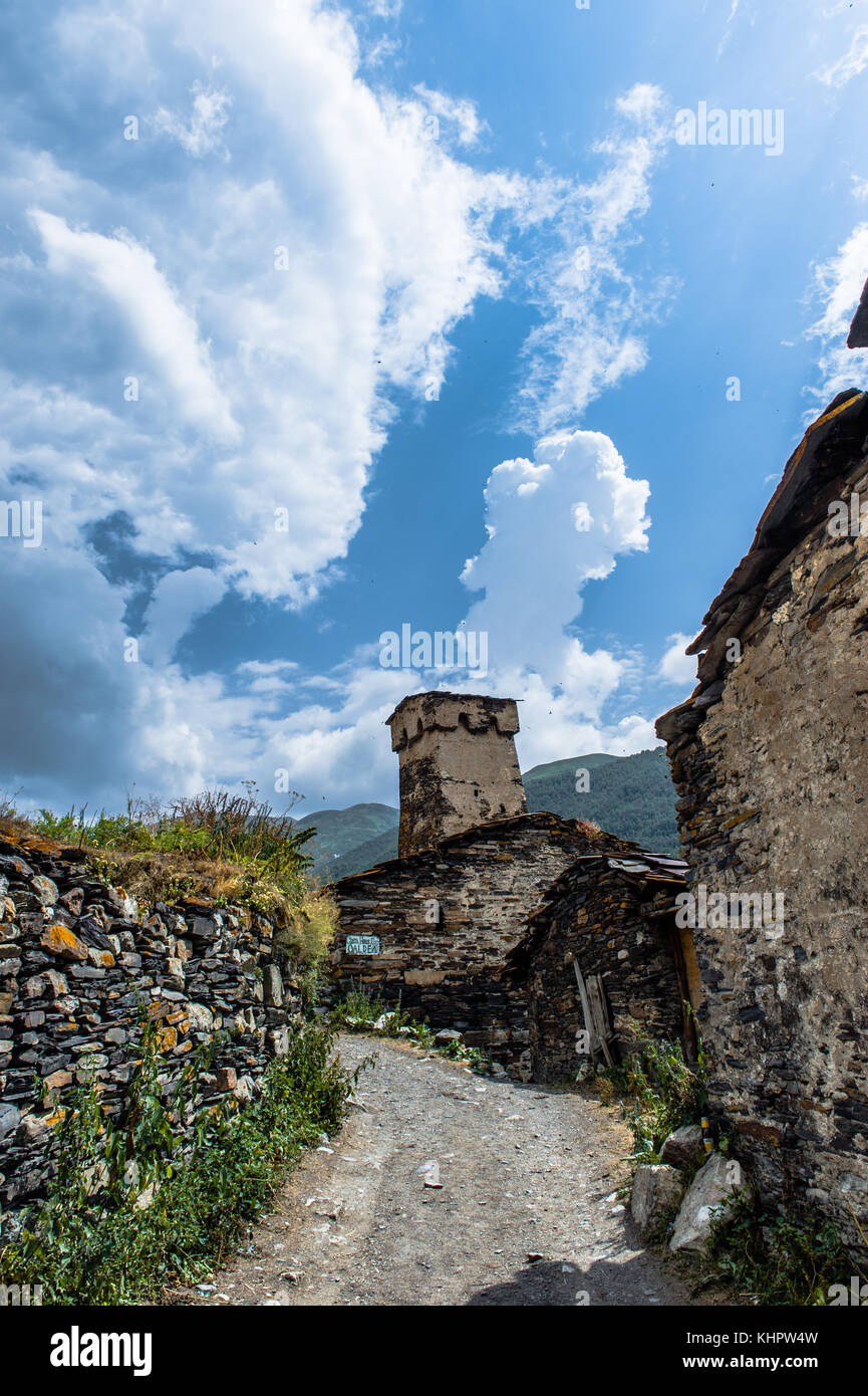 Village Ushguli landscape with massive rocky mountains Bezengi wall ...
