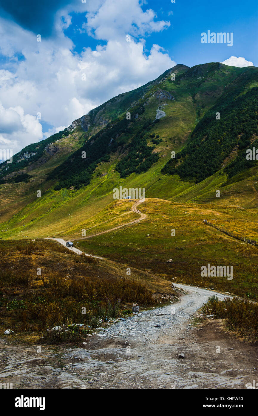 Village Ushguli landscape with massive rocky mountains Bezengi wall ...