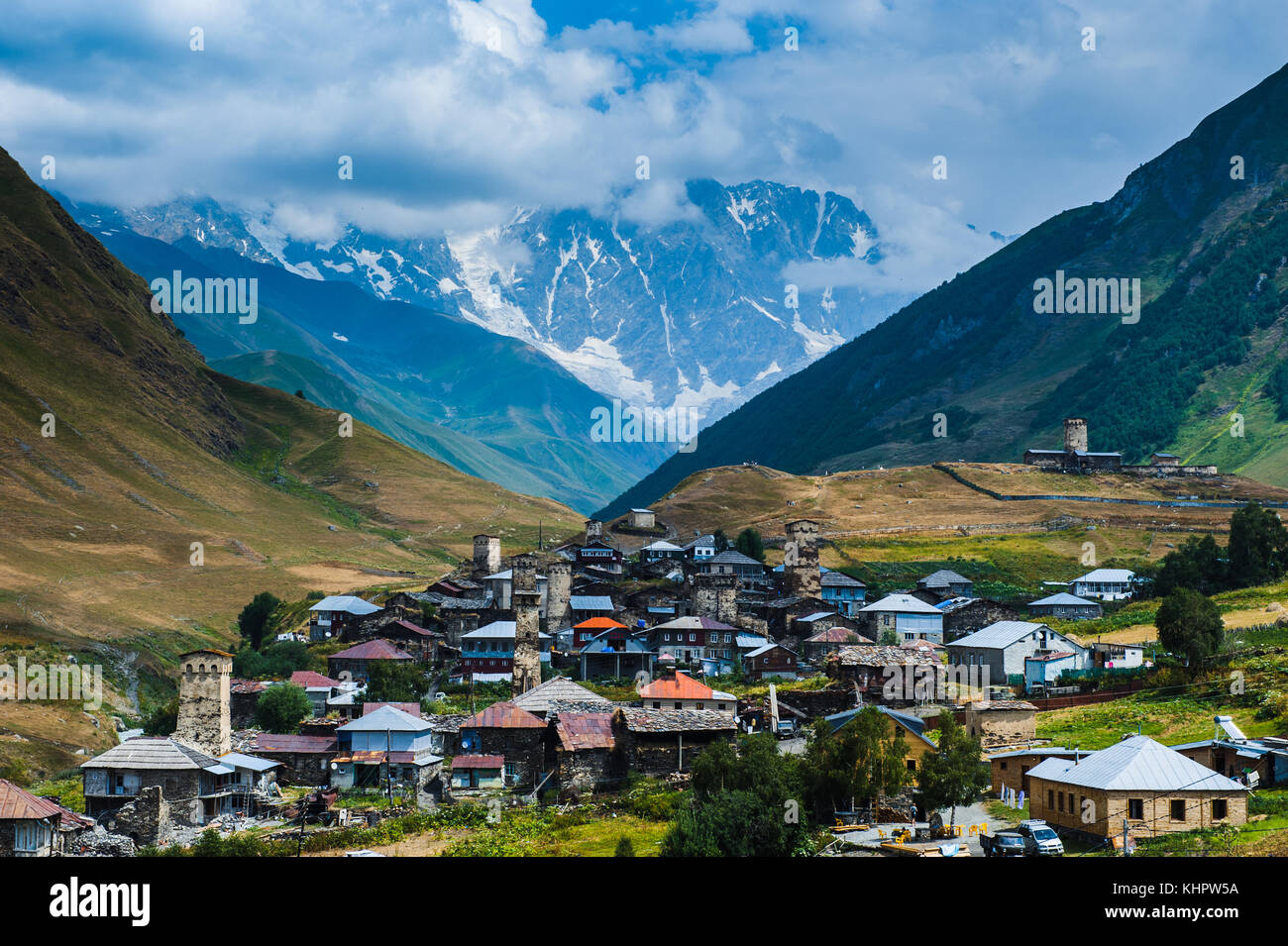 Village Ushguli landscape with massive rocky mountains Bezengi wall ...