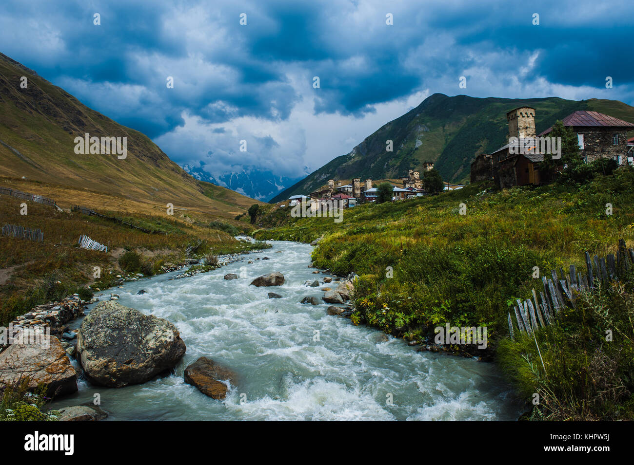 Village Ushguli landscape with massive rocky mountains Bezengi wall ...
