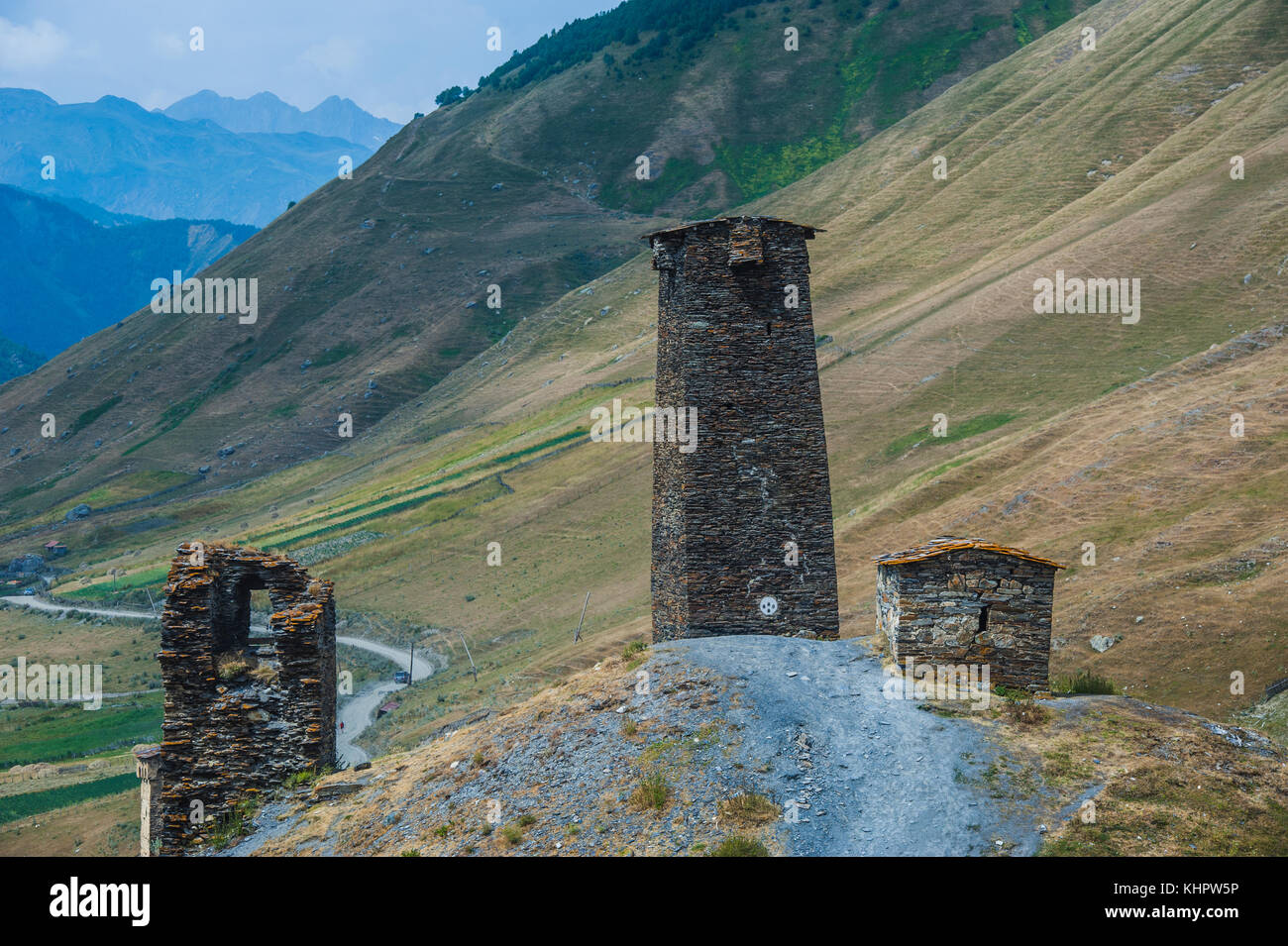 Village Ushguli landscape with massive rocky mountains Bezengi wall ...