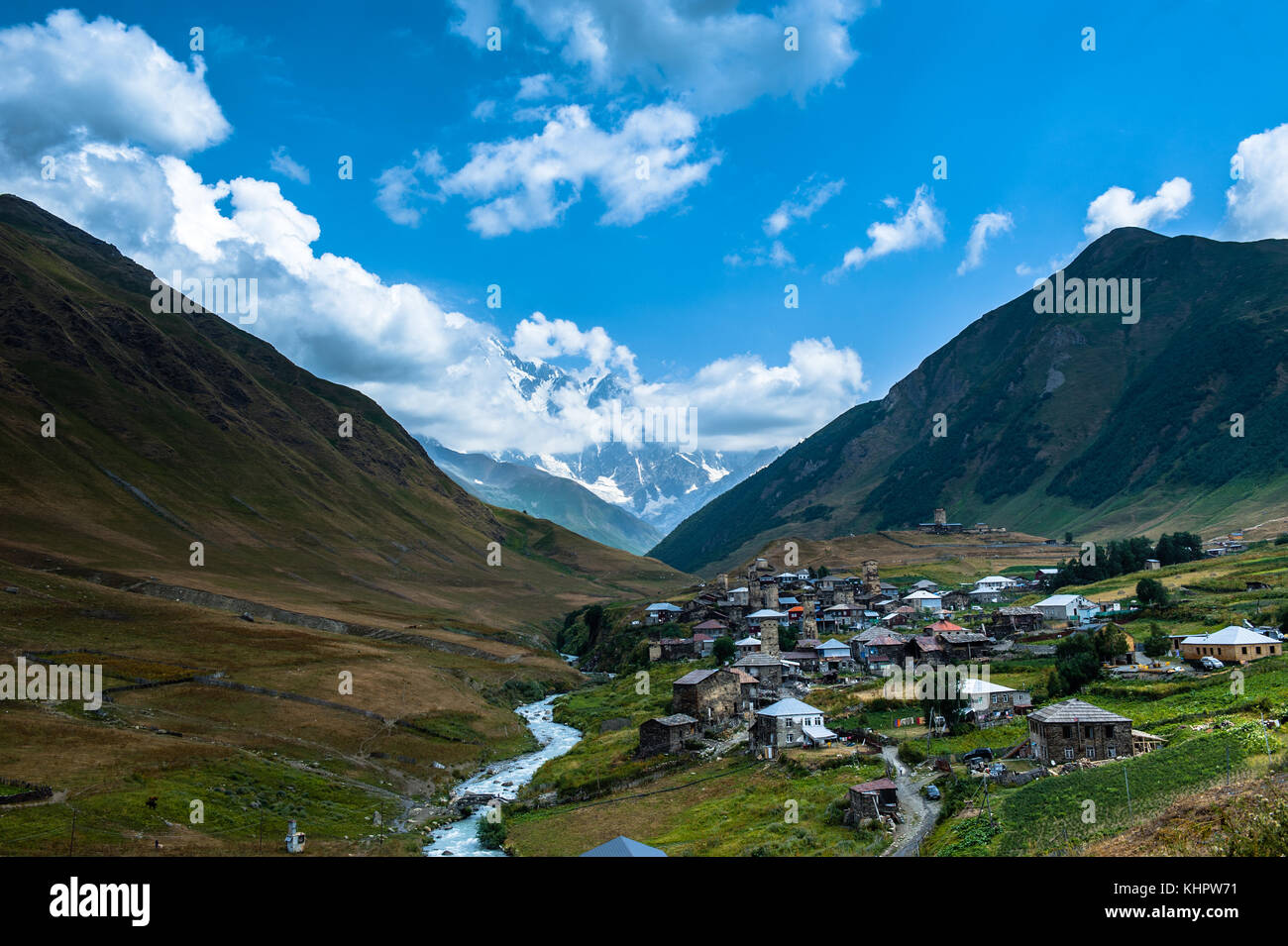 Village Ushguli landscape with massive rocky mountains Bezengi wall ...