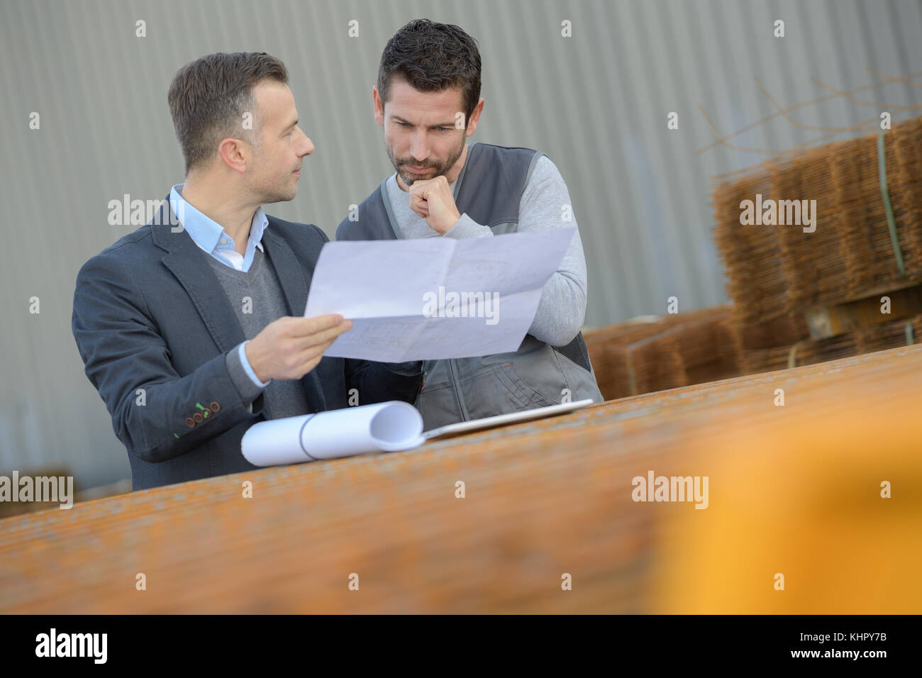 factory worker and boss checking a paper Stock Photo - Alamy