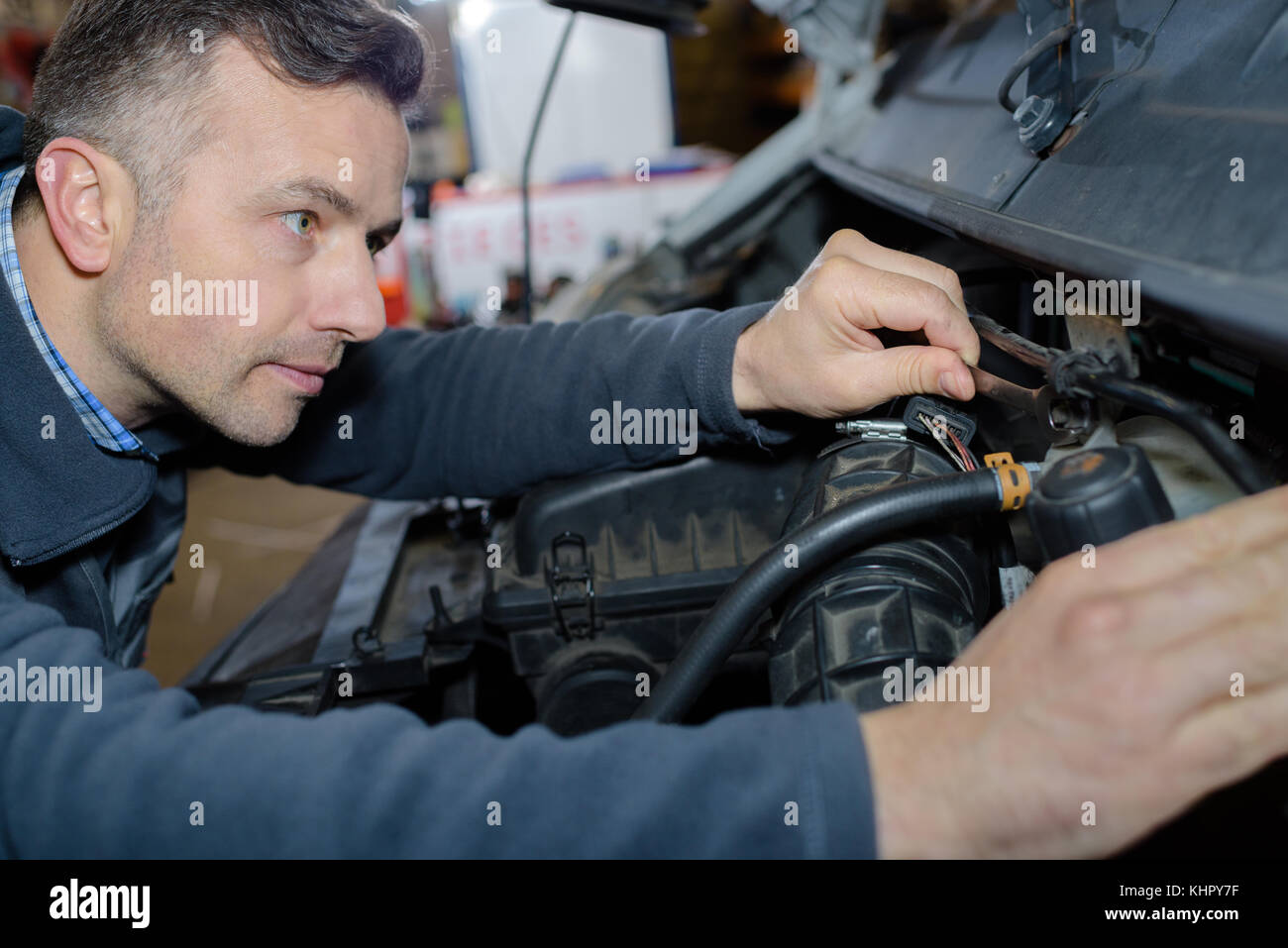 a closeup of a mechanic working on engine Stock Photo - Alamy