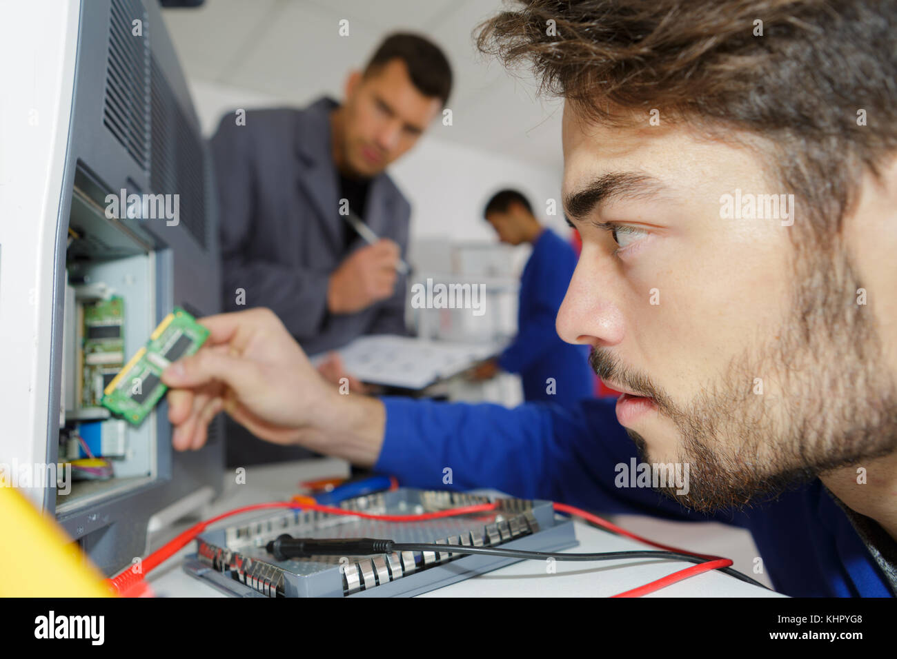 technician fitting component into computer Stock Photo - Alamy