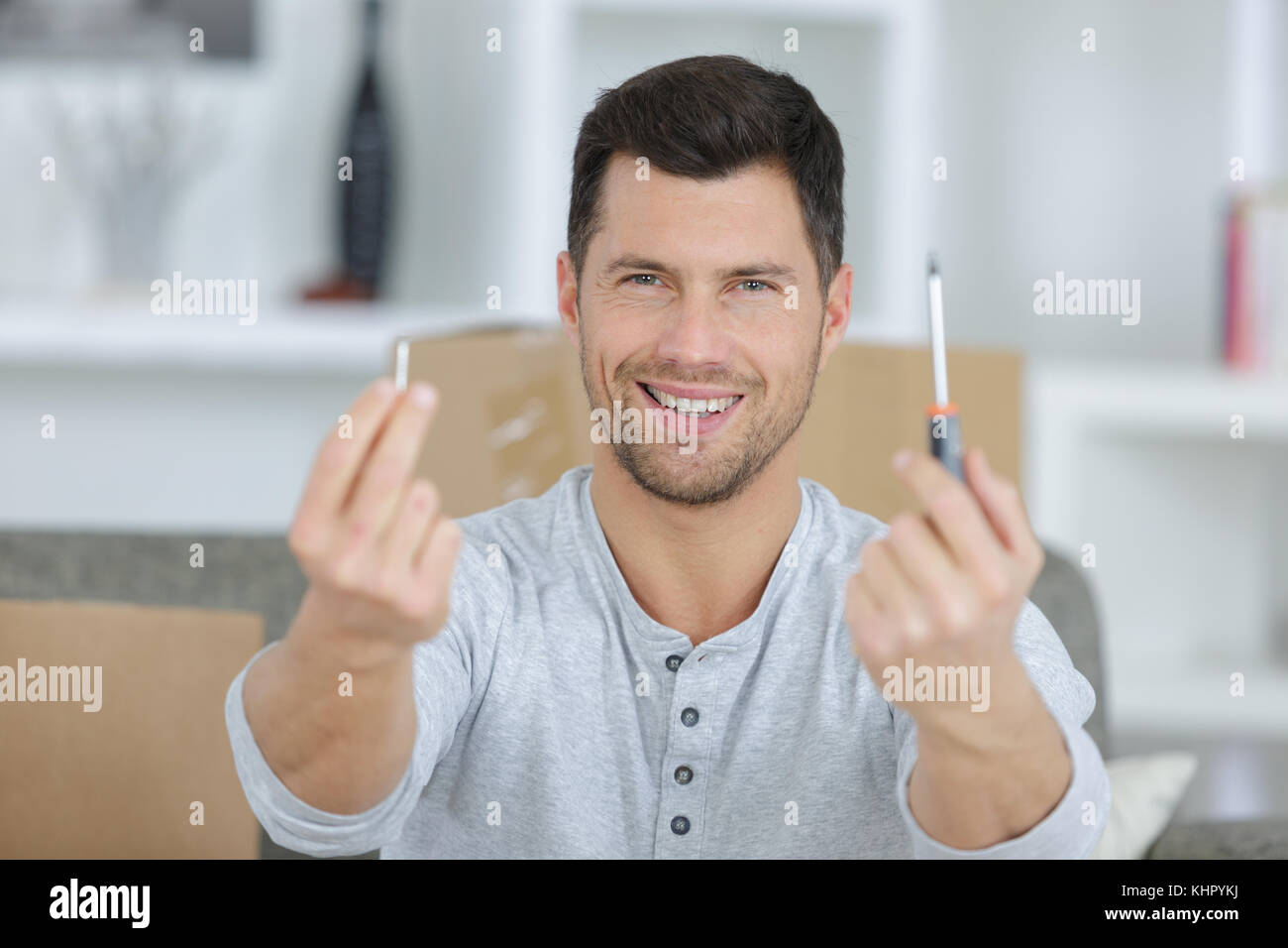 man holding a screwdriver Stock Photo - Alamy