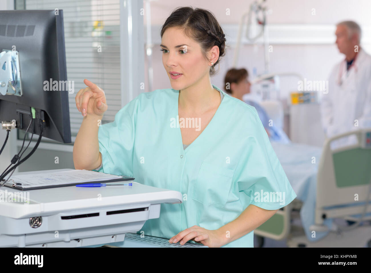 Nurse reading computer screen Stock Photo - Alamy