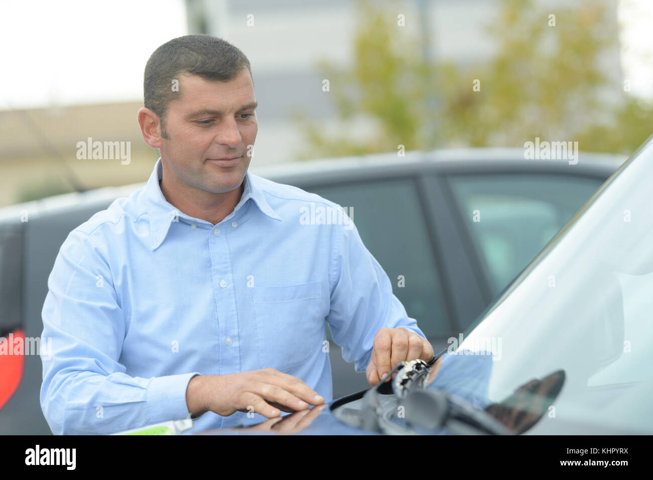 man inspecting a car Stock Photo - Alamy
