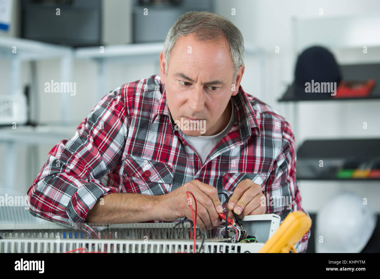 Technician testing heater with multimeter Stock Photo - Alamy