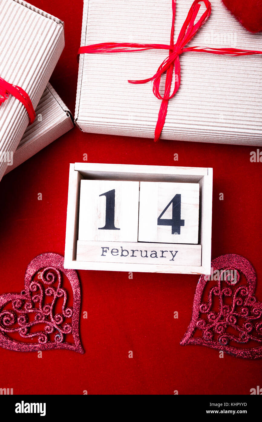 Wooden calendar show of February 14 with red heart and gift boxes Stock ...