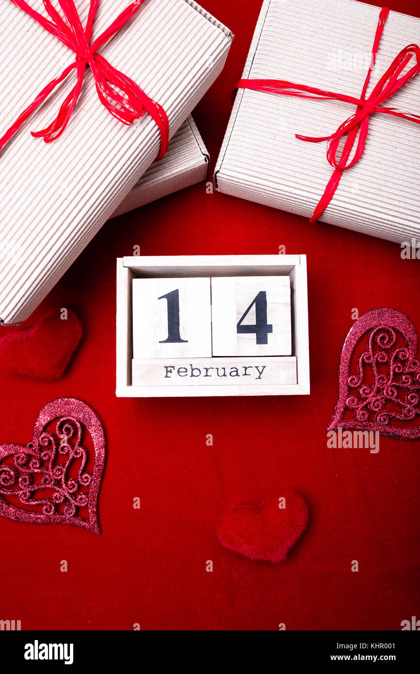 Wooden calendar show of February 14 with red heart and gift boxes Stock ...
