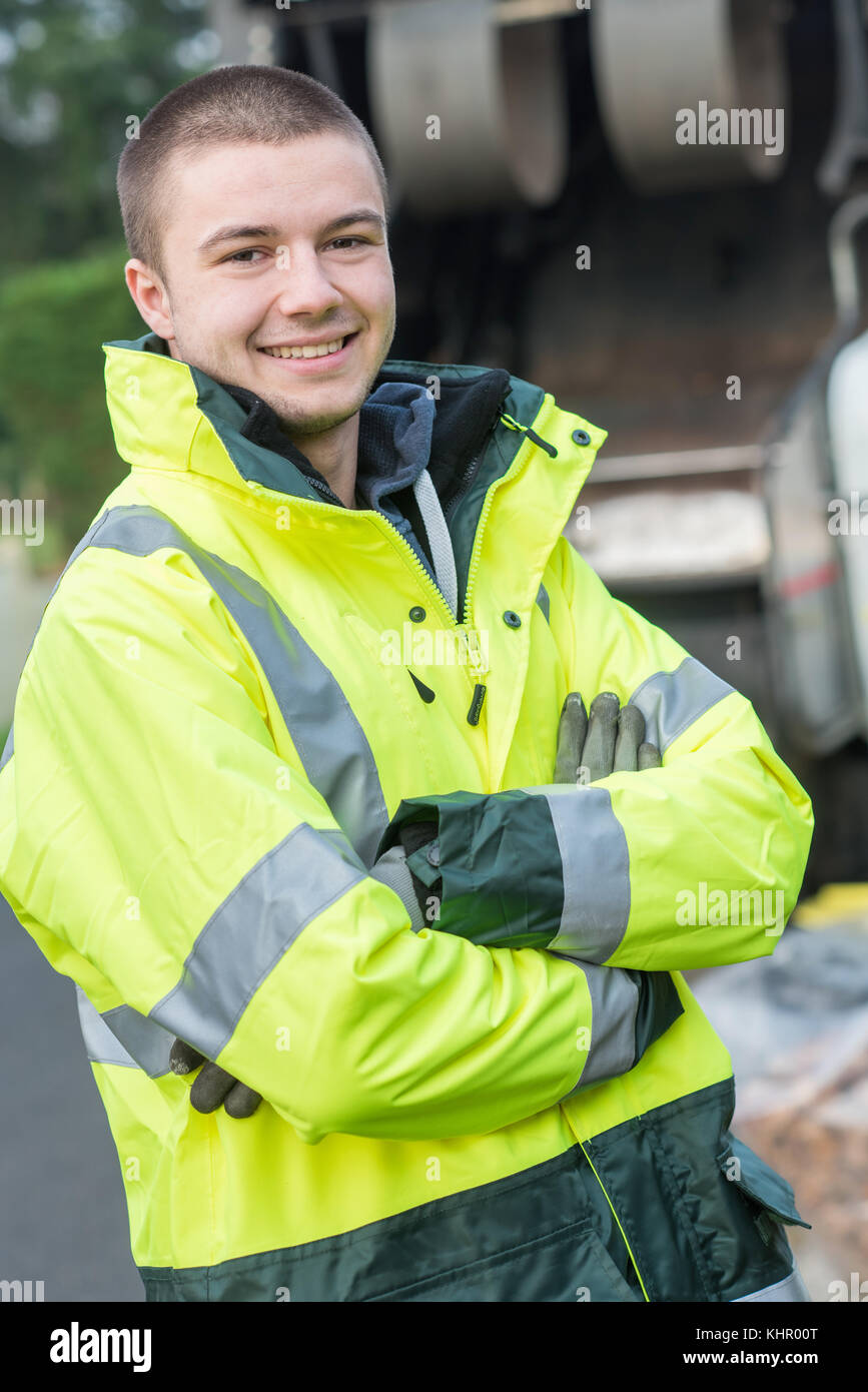 happy young working man standing near dustbin on street Stock Photo - Alamy