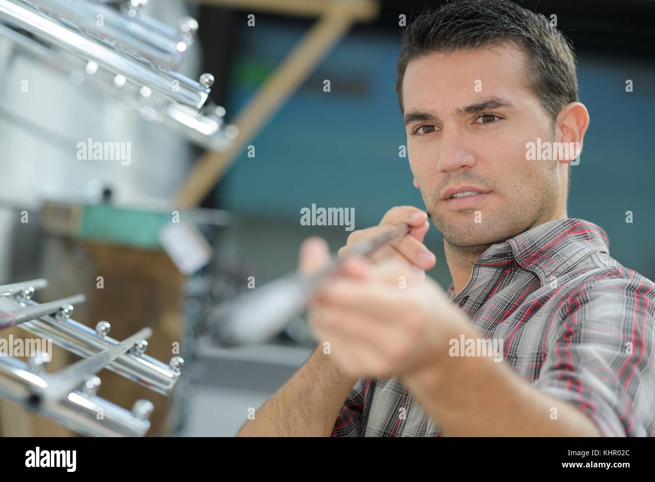 man holding a metal bar Stock Photo - Alamy