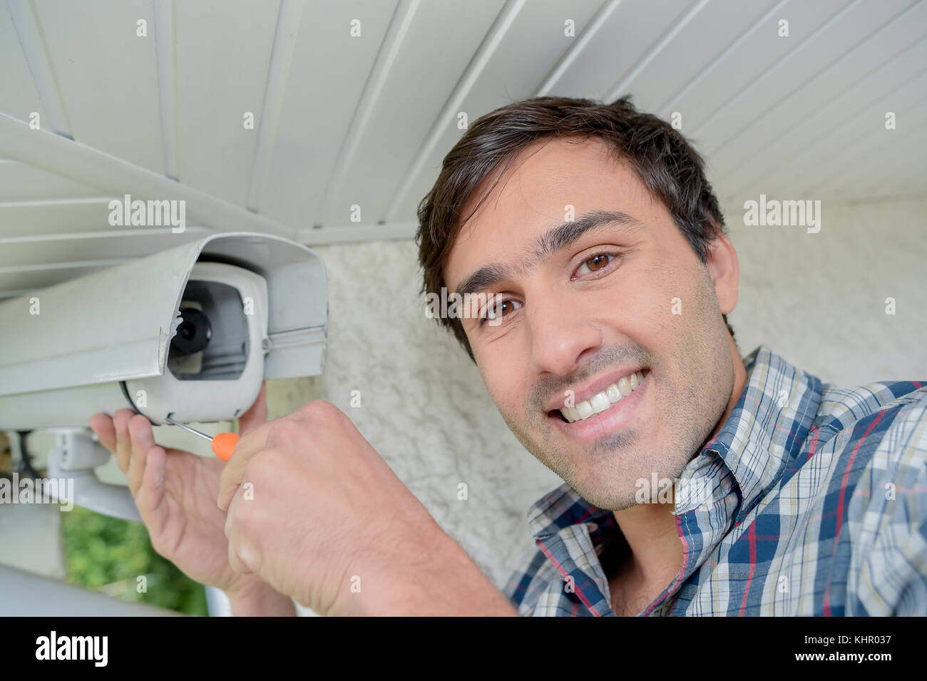 Installing a security camera Stock Photo - Alamy