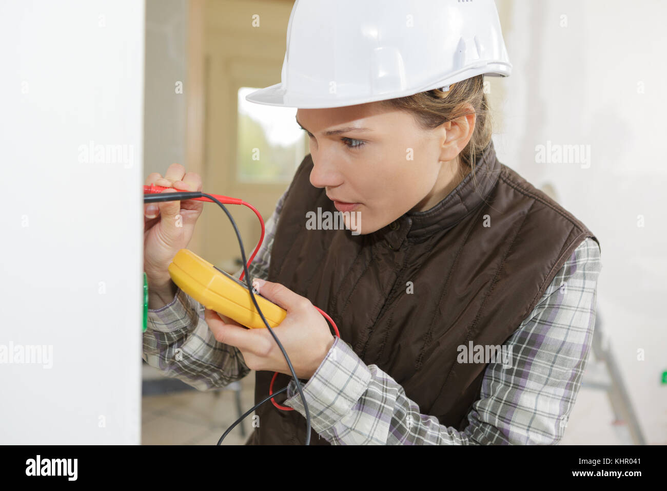 female electrician testing a wall socket Stock Photo - Alamy