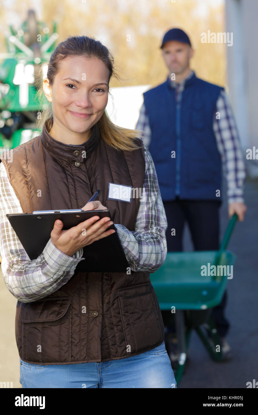 female smiling coworkers looking at clipboard Stock Photo - Alamy