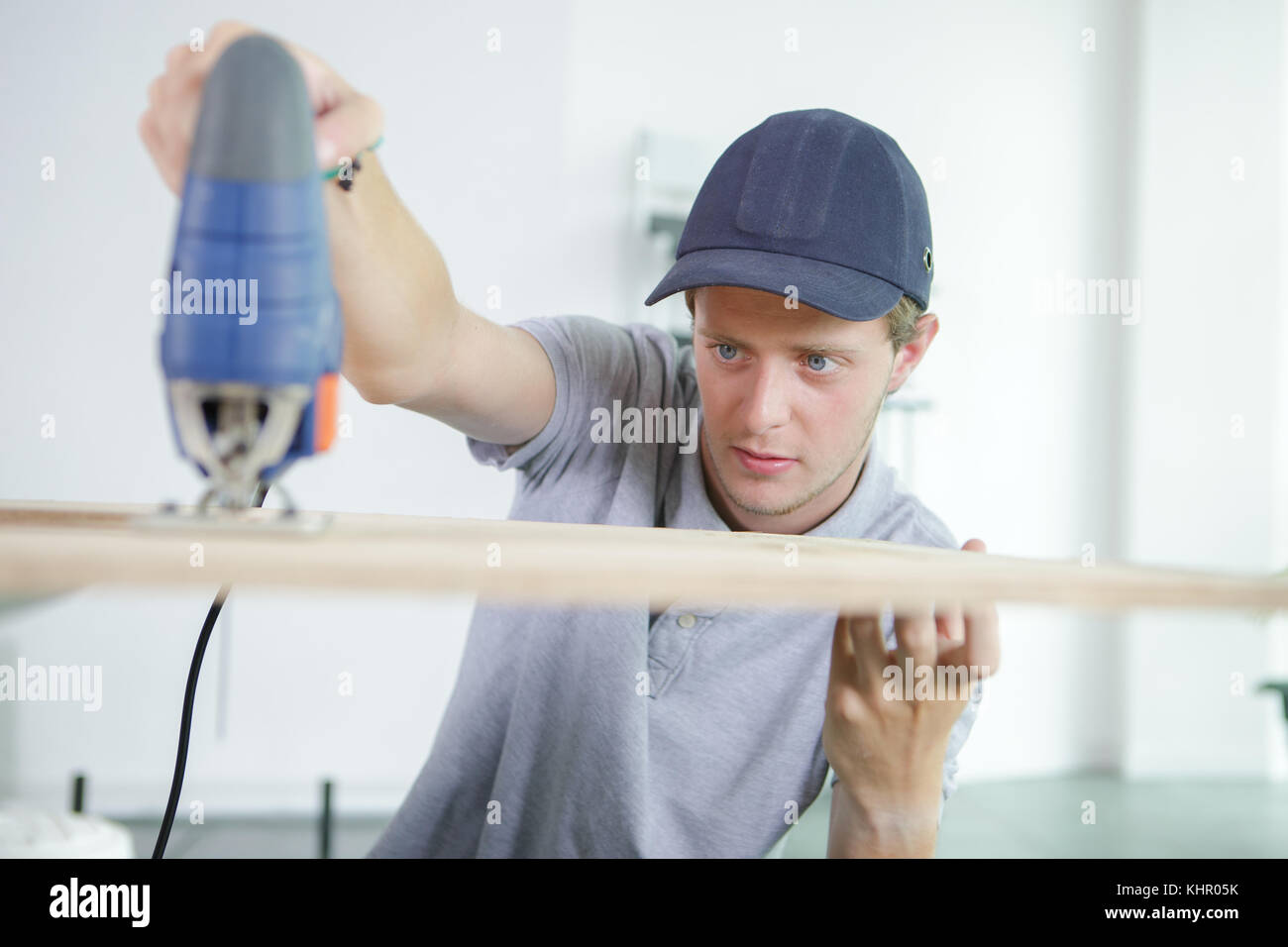 Man using jigsaw Stock Photo - Alamy