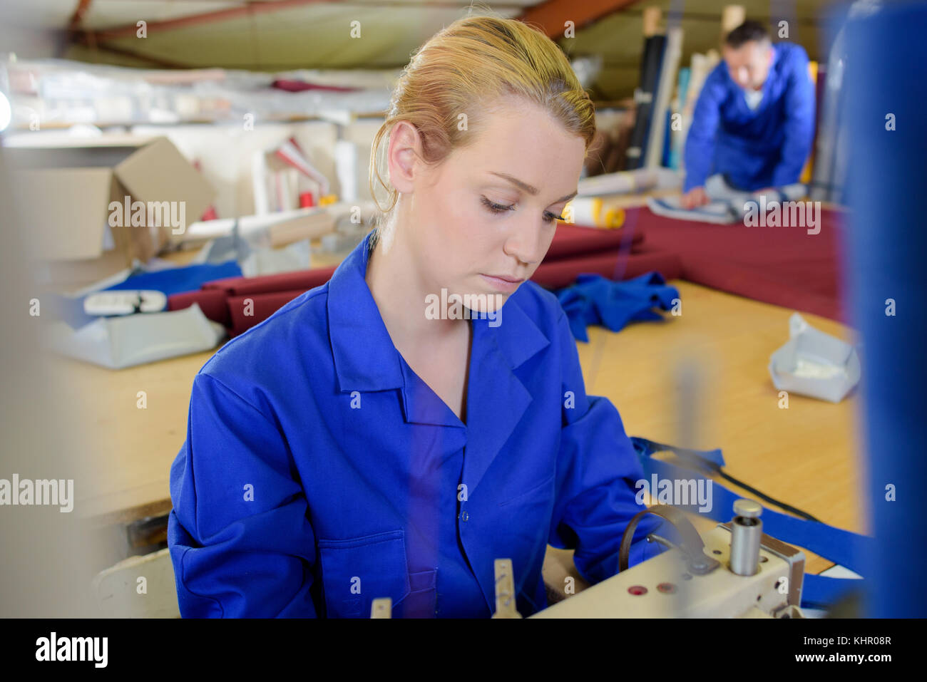Woman using sewing machine Stock Photo - Alamy