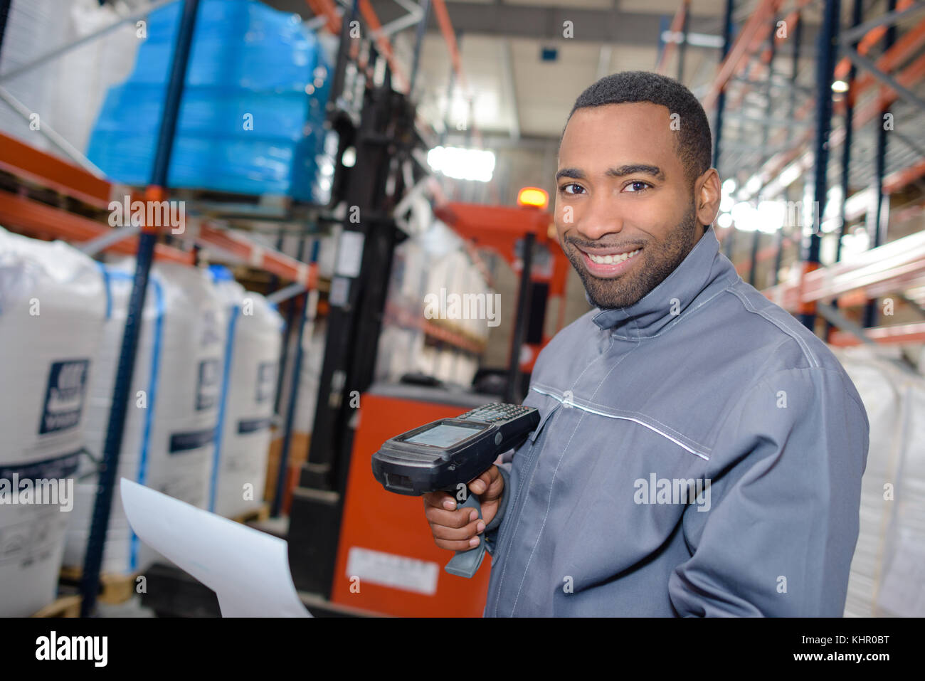 Warehouse worker holding scanner Stock Photo - Alamy